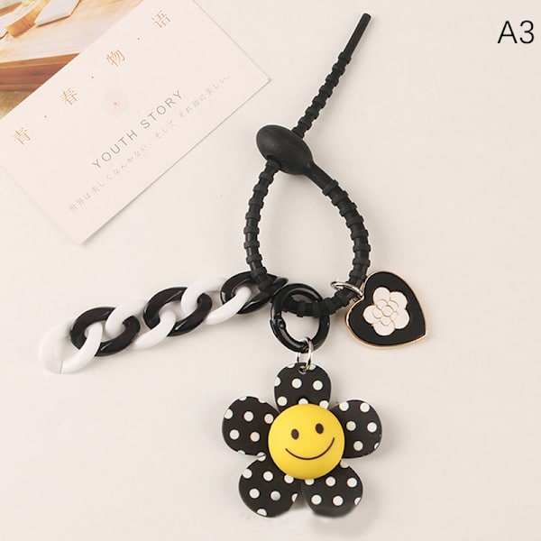 Trendig solblomma Smiley nyckelring Leende blomma nyckelring med H A3 ...